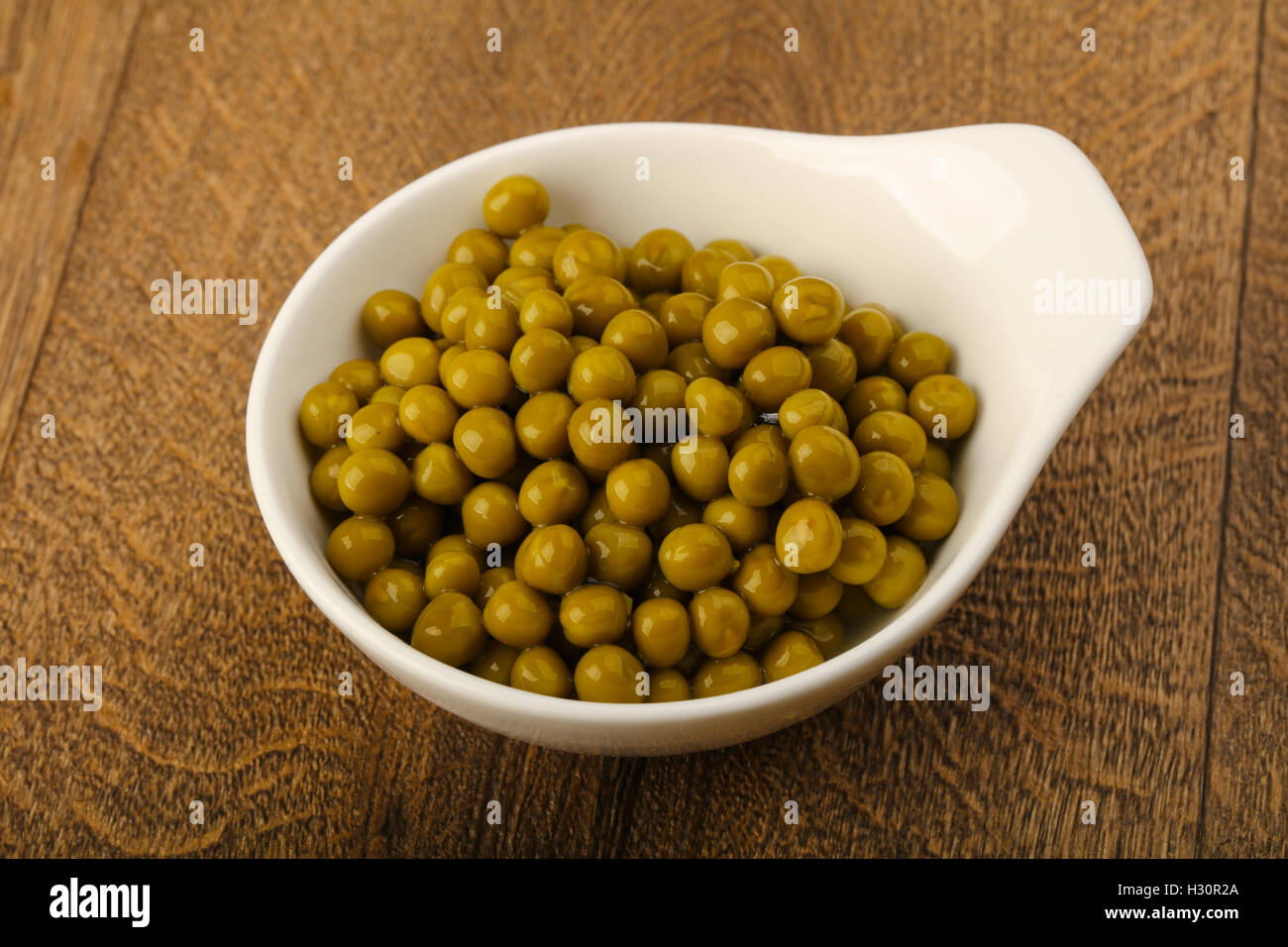 Pickled green pea on the wood background Stock Photo - Alamy