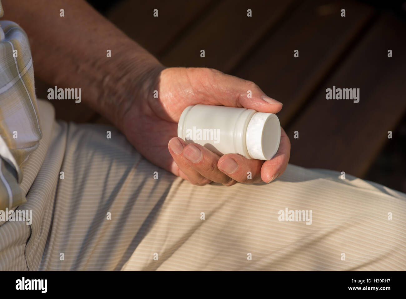 Male hand with pill bottle Stock Photo - Alamy
