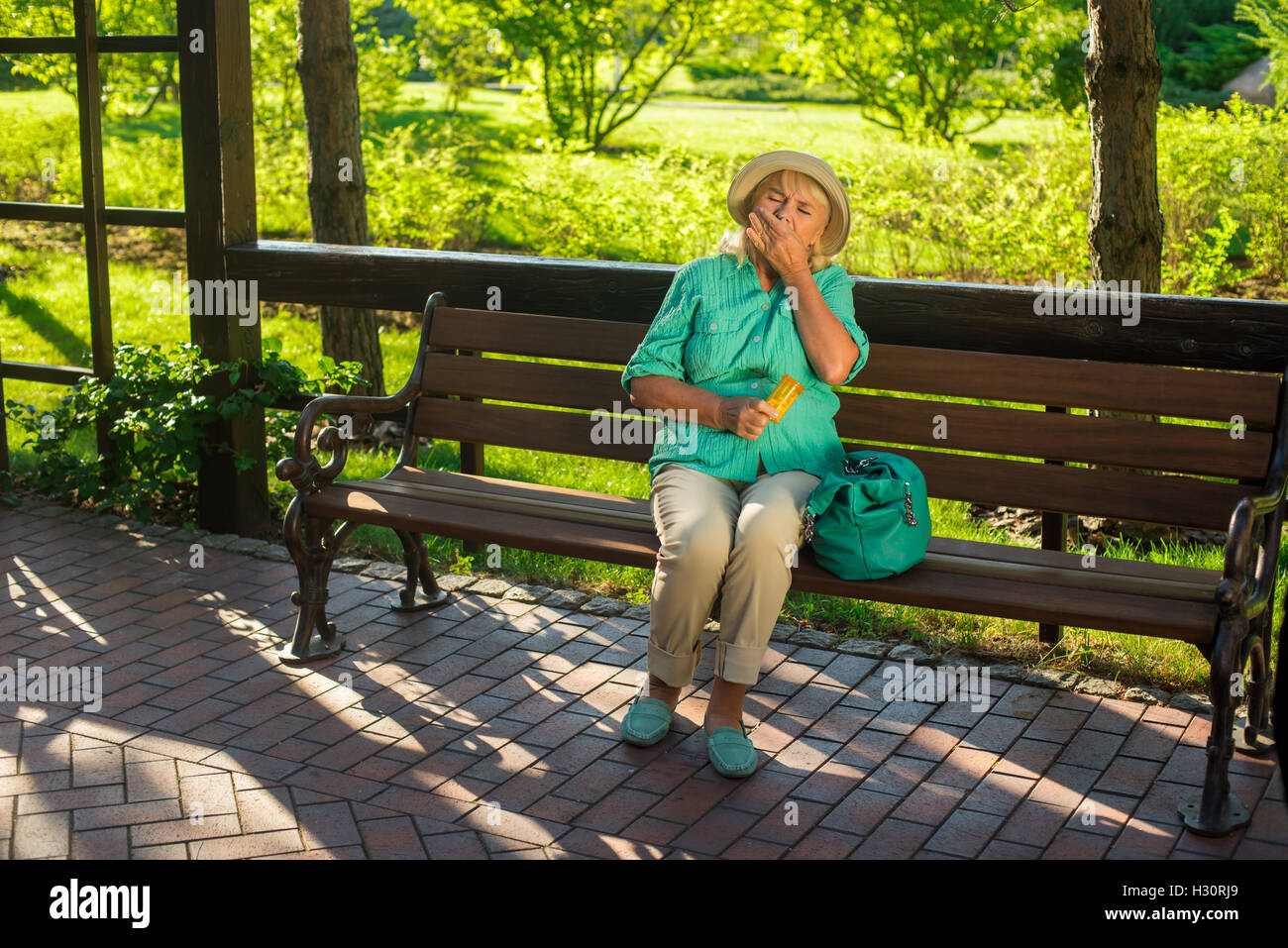 Mature woman eating pills Stock Photo - Alamy