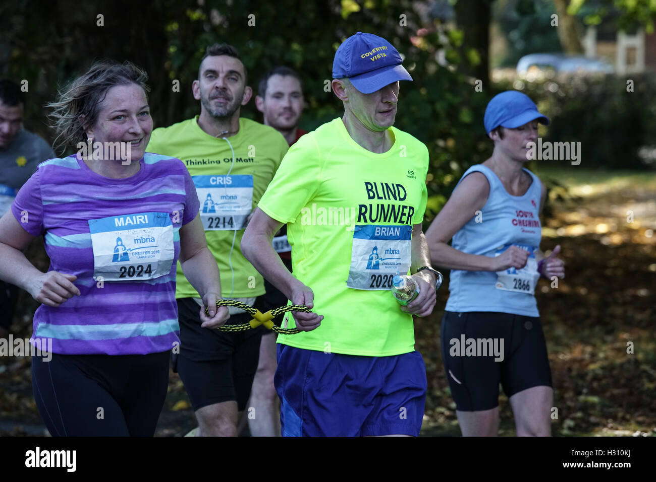 A blind runner in the Chester Marathon reaches Pulford with her running companion Stock Photo ...