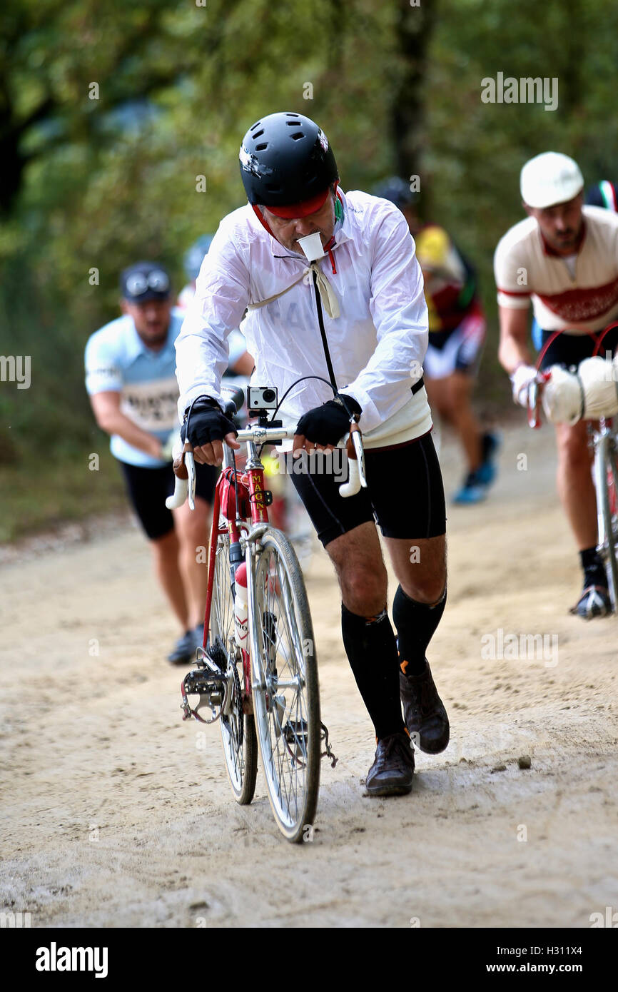 Tuscany, Italy. 2nd Oct, 2016. A cyclist, with a coffee cup in his ...