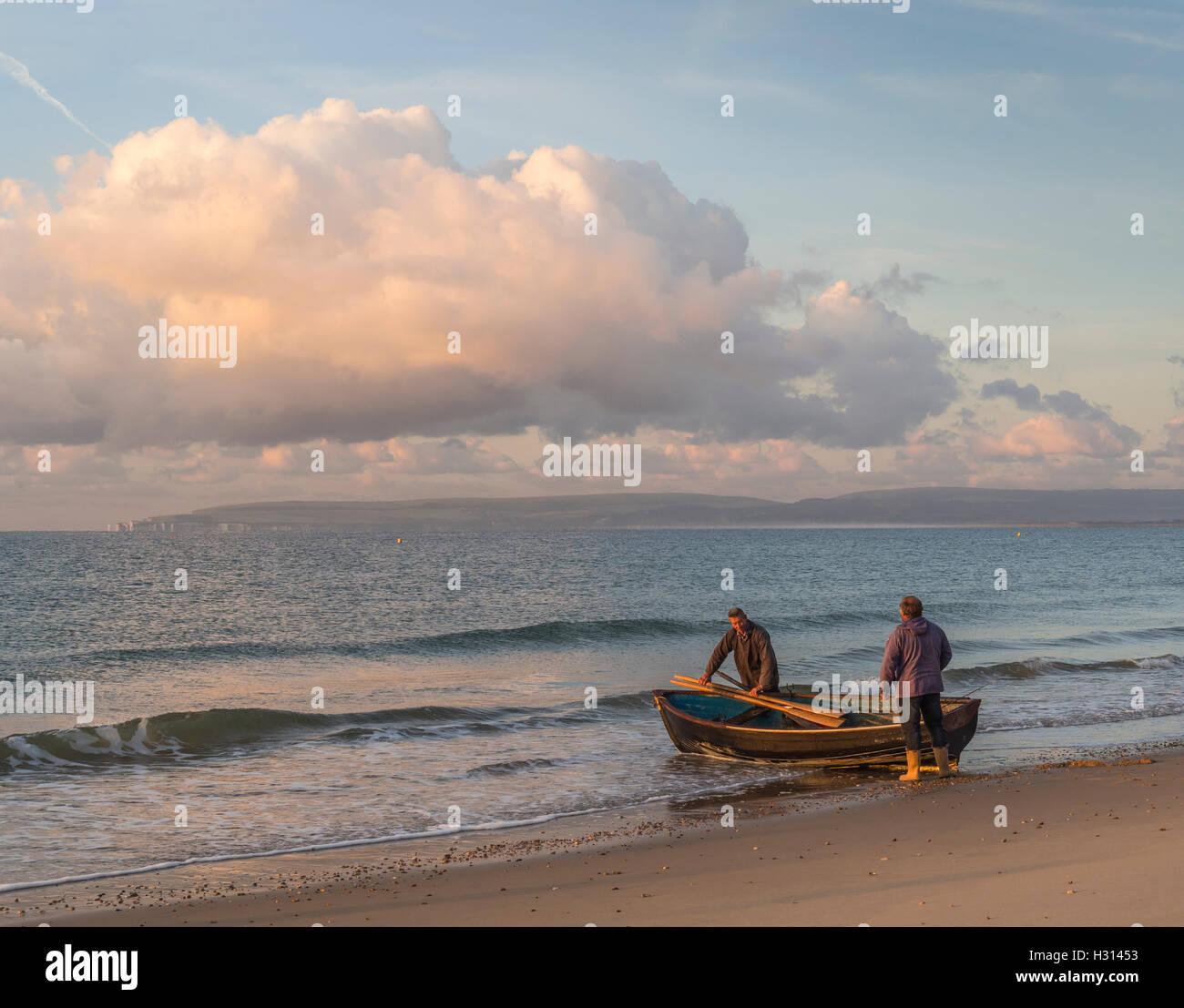 Two men launching a boat hi-res stock photography and images - Alamy