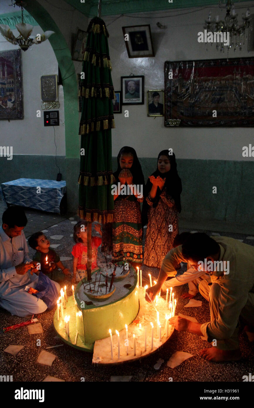 Peshawar. 3rd Oct, 2016. Pakistani Shiite Muslims light candles at a ...