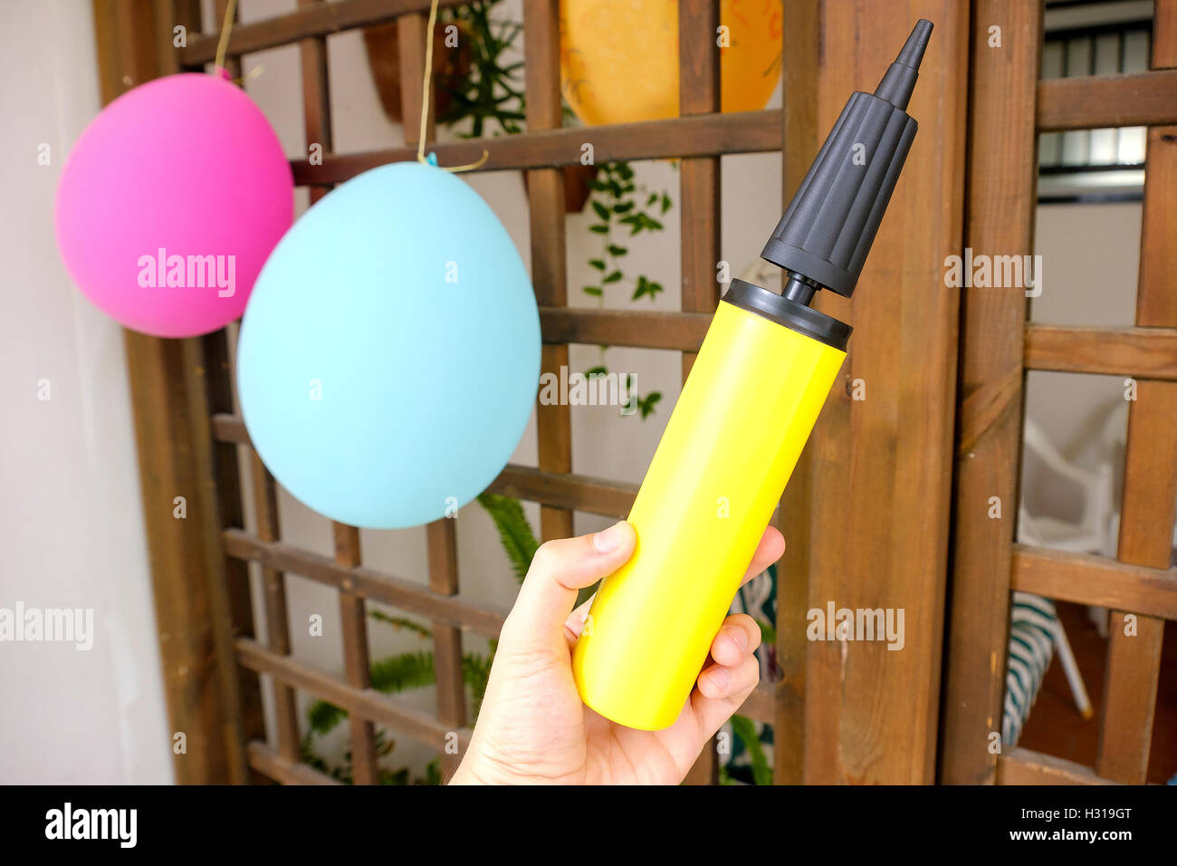 balloons pump hand party Stock Photo - Alamy
