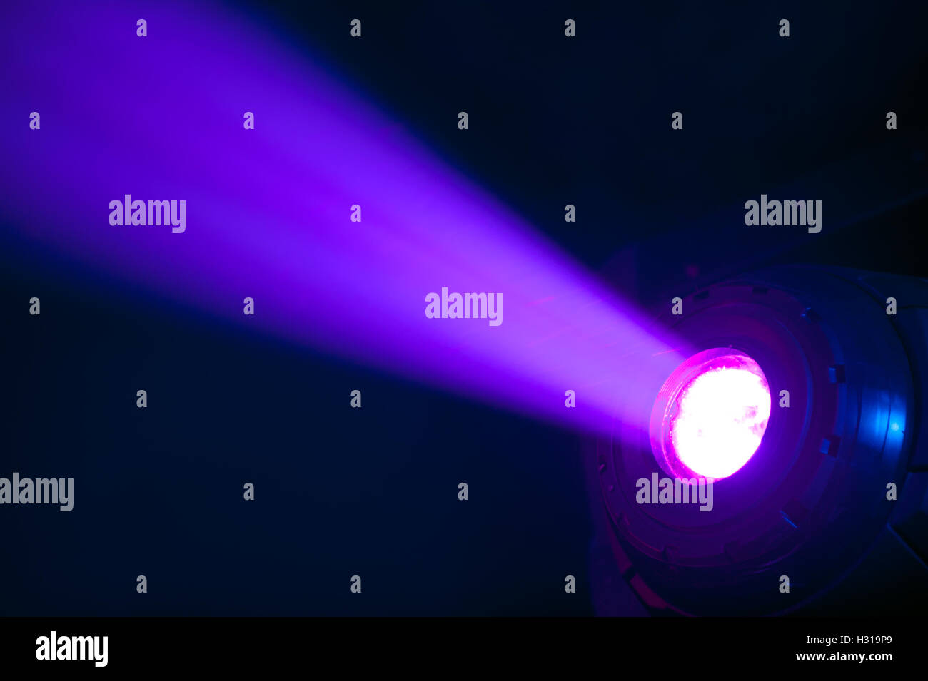 Stage spotlight with purple light beam over dark background Stock Photo ...
