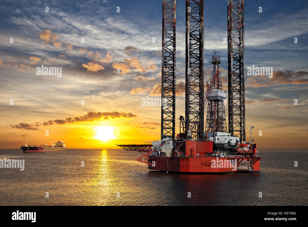 Oil platform and tanker ship on offshore area at sunset Stock Photo - Alamy