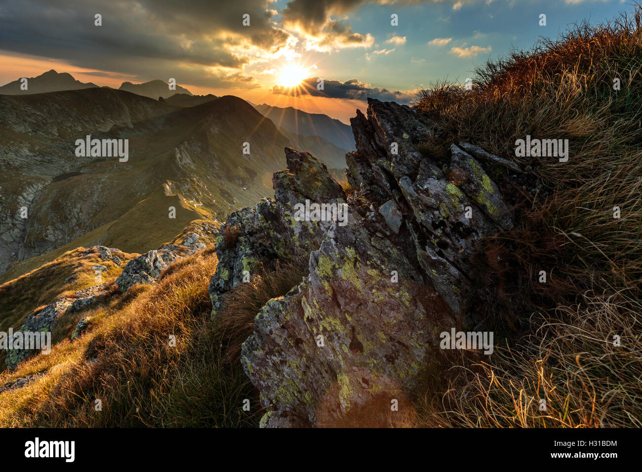 Landscape with mountain peaks at sunset in the golden hour Stock Photo ...