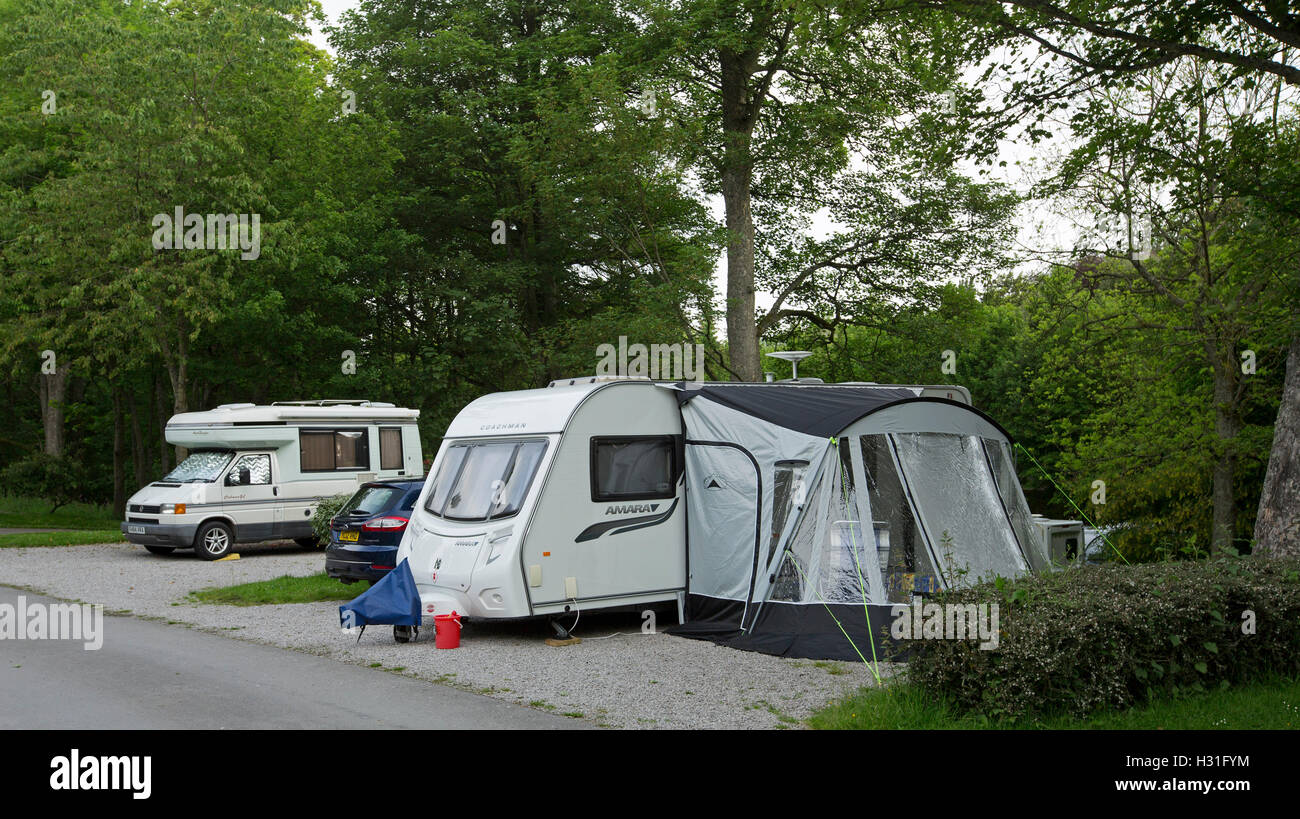 Caravan with annexe erected and campervan / mobile home parked beneath ...