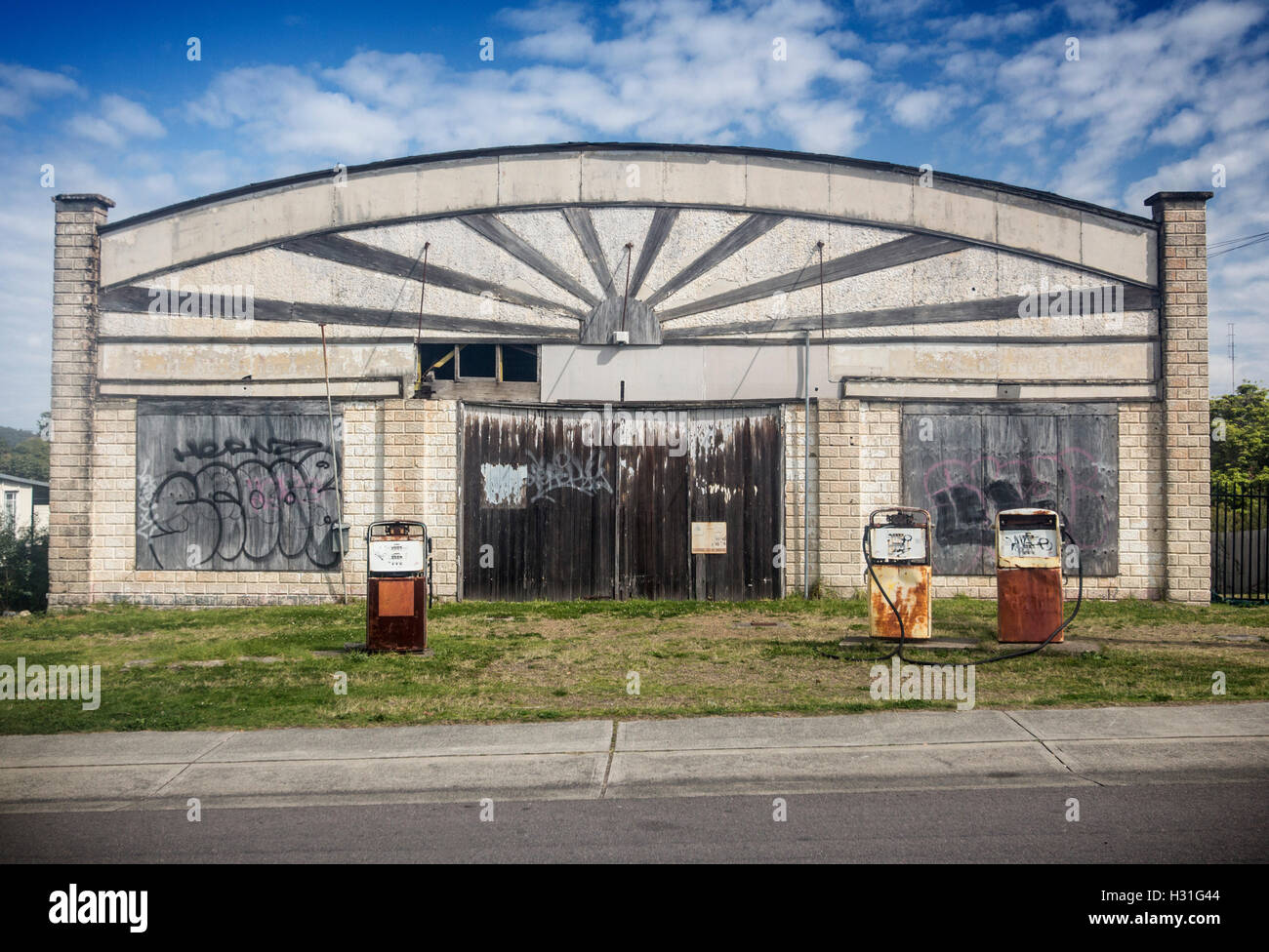 Disused vintage garage gas station petrol station with petrol pumps and ...