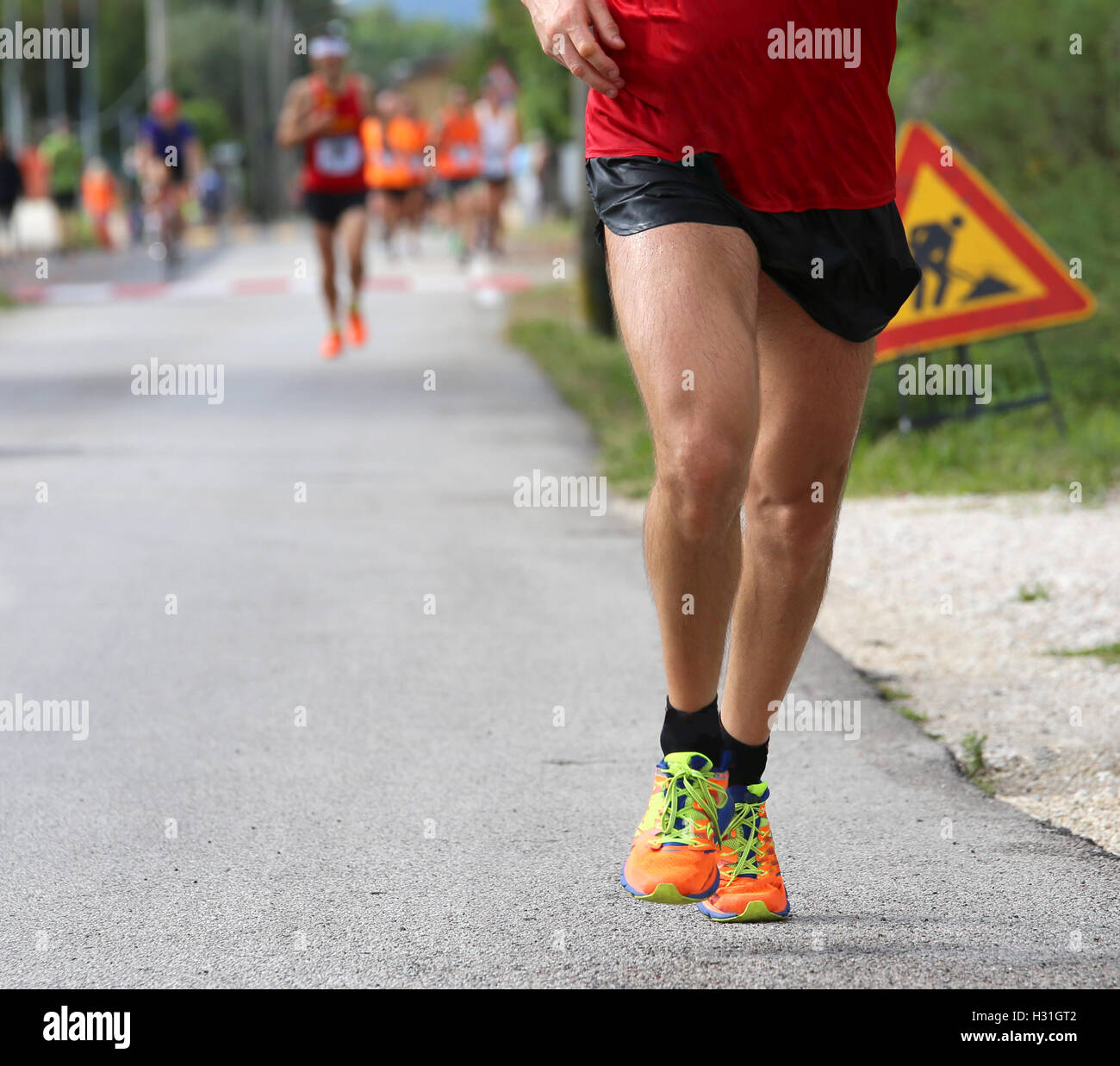 muscular runner during a marathon race in the city Stock Photo - Alamy