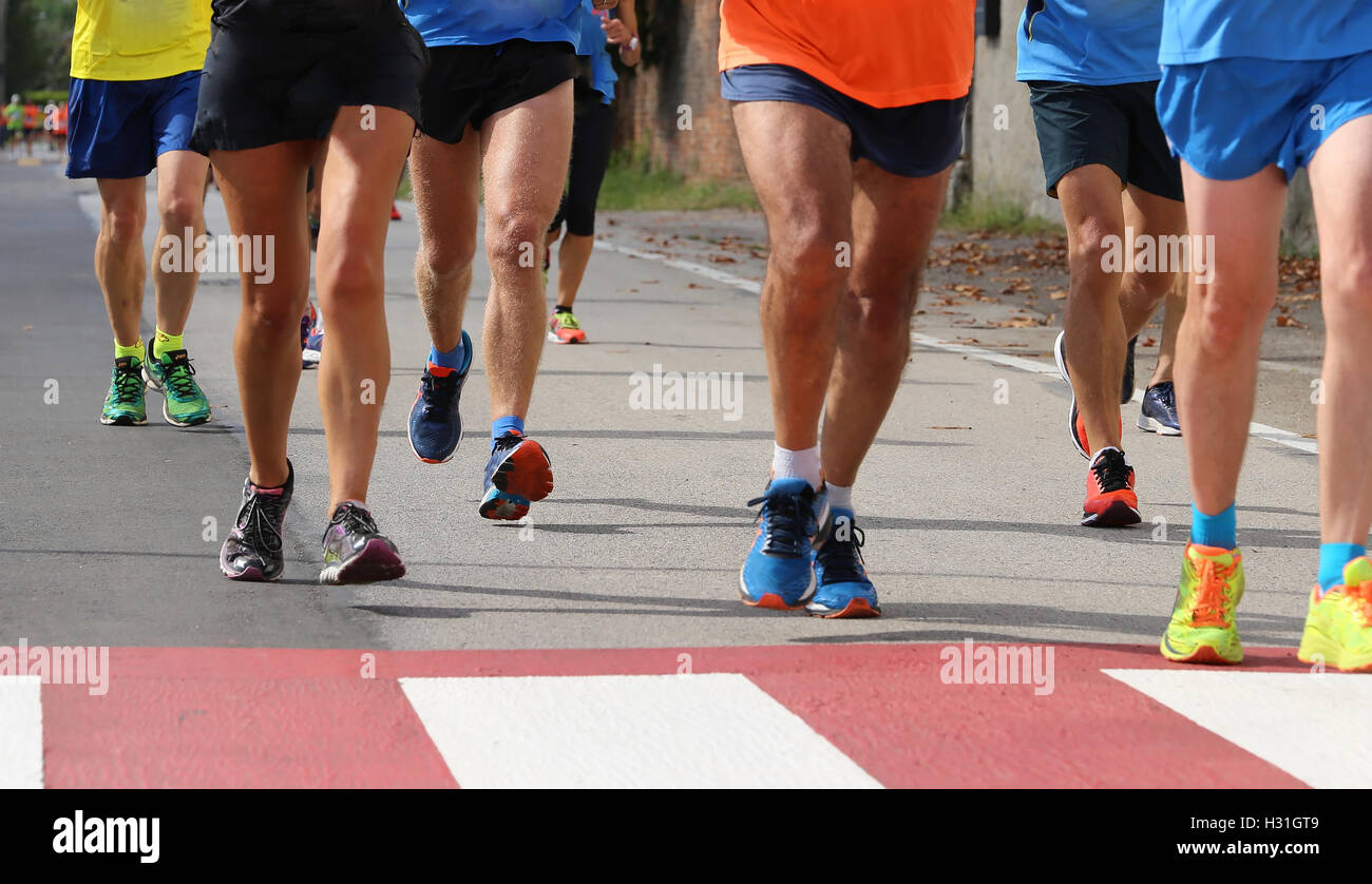many fast runners during a marathon race in the city on a pedestrian ...