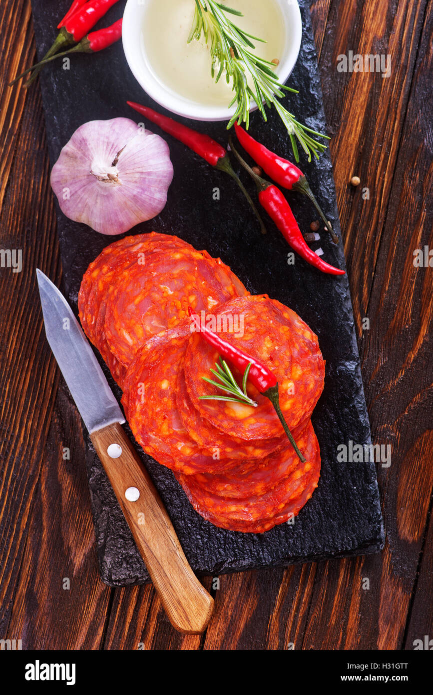 chorizo on wooden board and on a table Stock Photo - Alamy