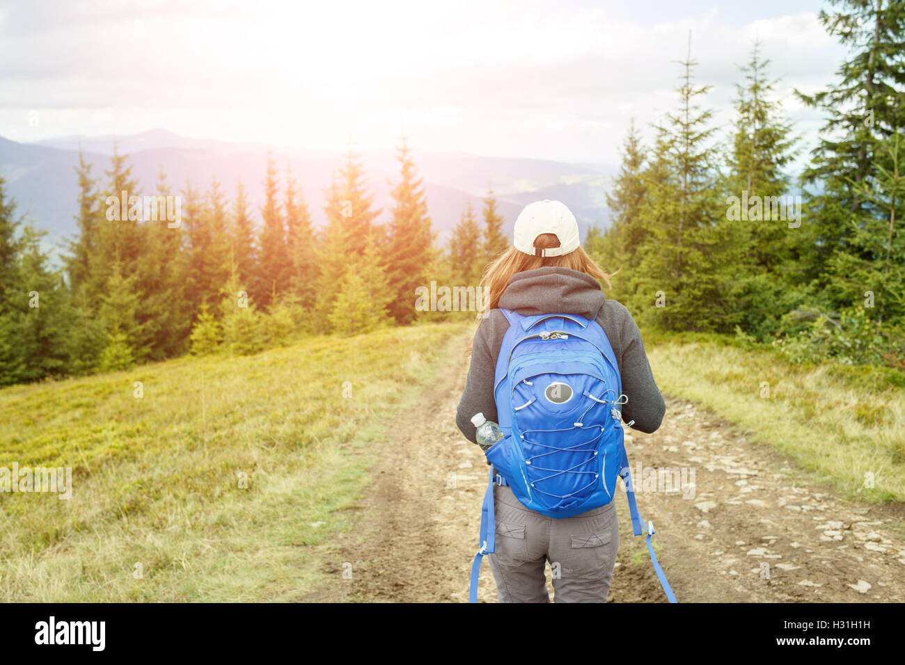 Young backpacker woman enjoying mountain trip. Pretty caucasian girl ...