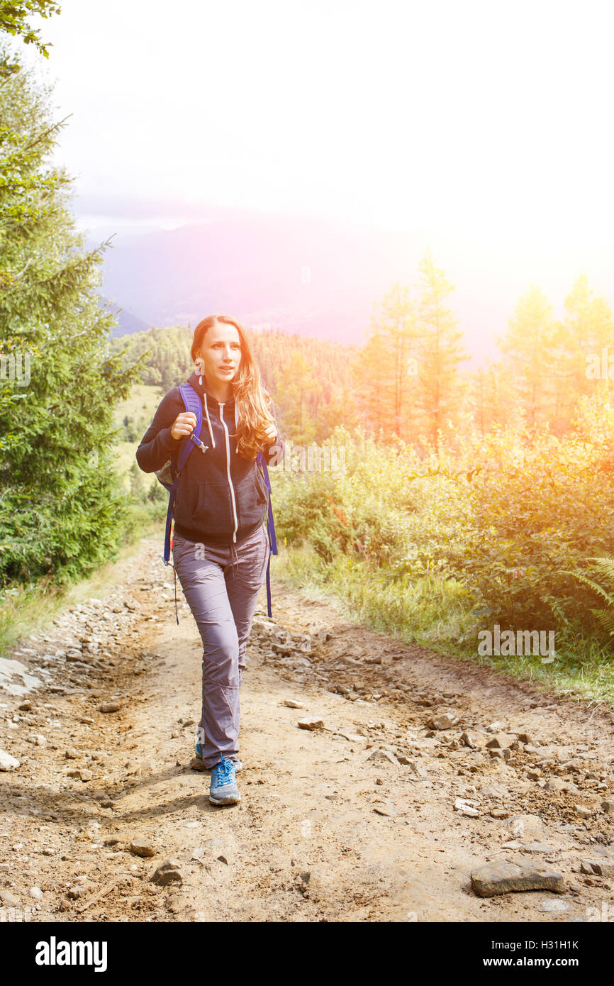 Young backpacker woman enjoying mountain trip. Pretty caucasian girl ...