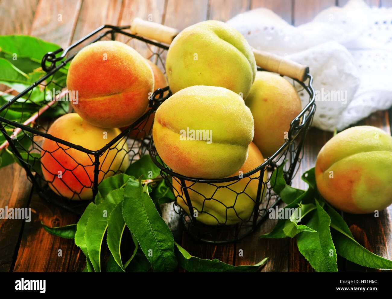 fresh peach in basket and on the wooden table Stock Photo - Alamy