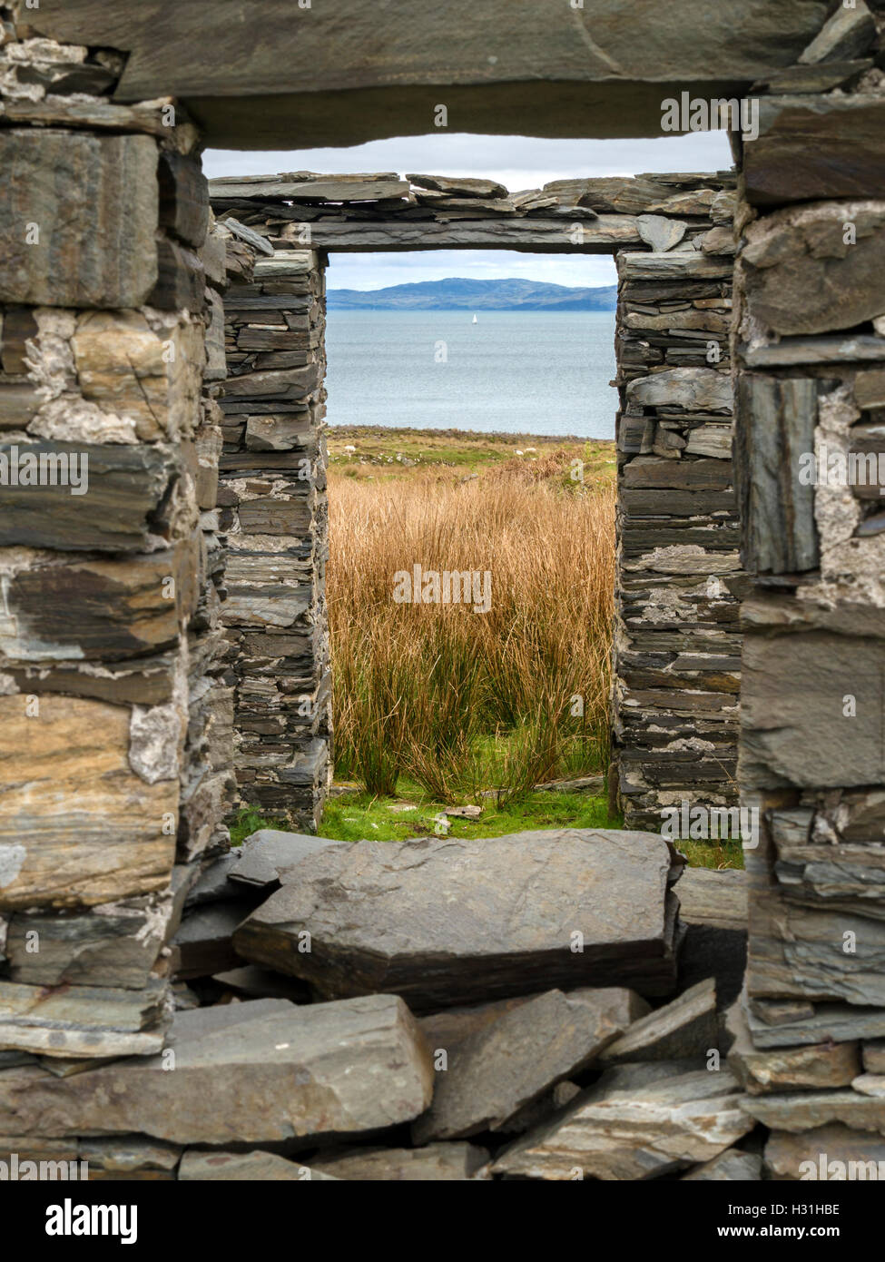 Empty old stone window and doorway framing the view at abandoned ...