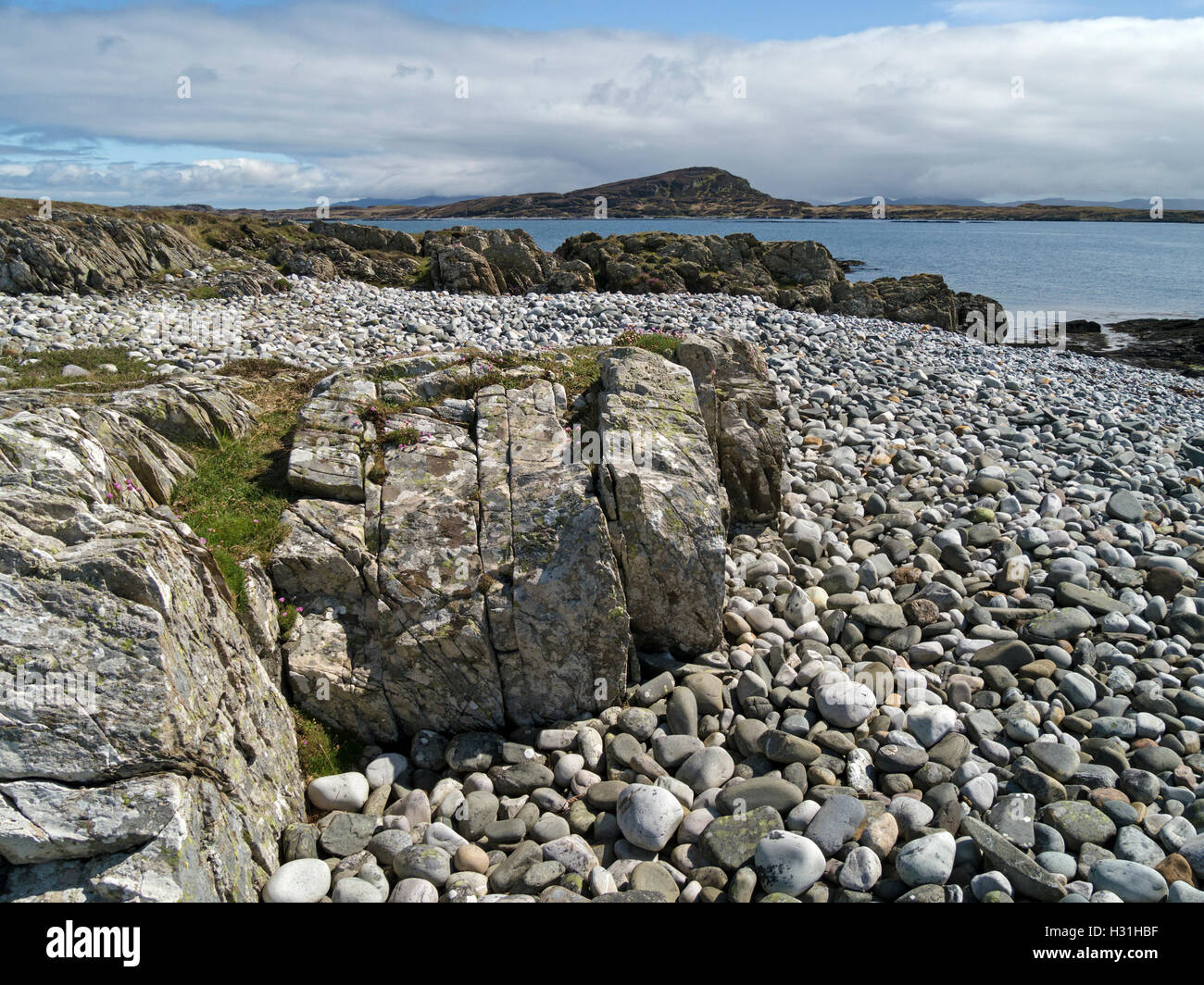 Pebble beach at Ardskenish on the Isle of Colonsay with the Isle of ...
