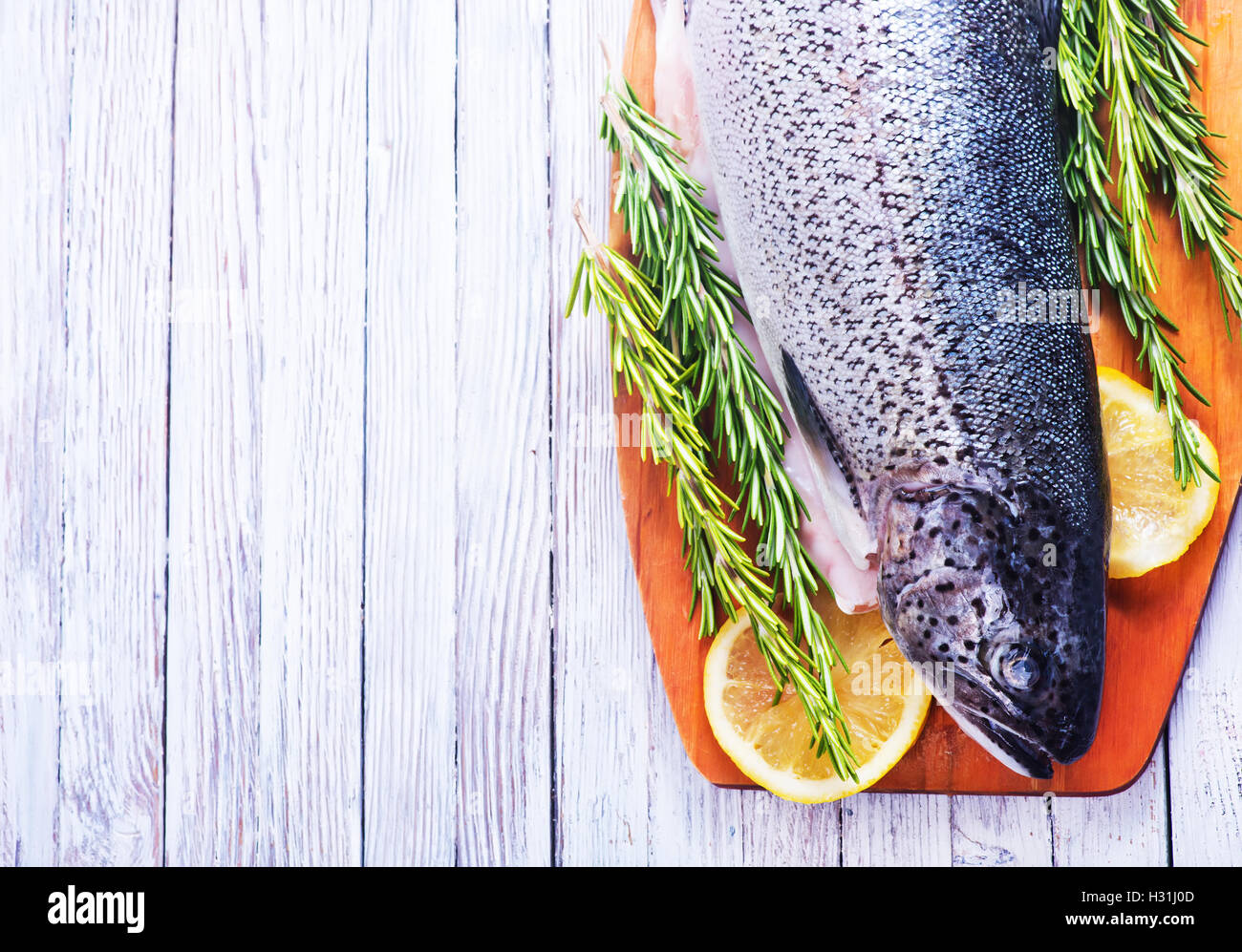 raw fish with spice and salt on a table Stock Photo - Alamy