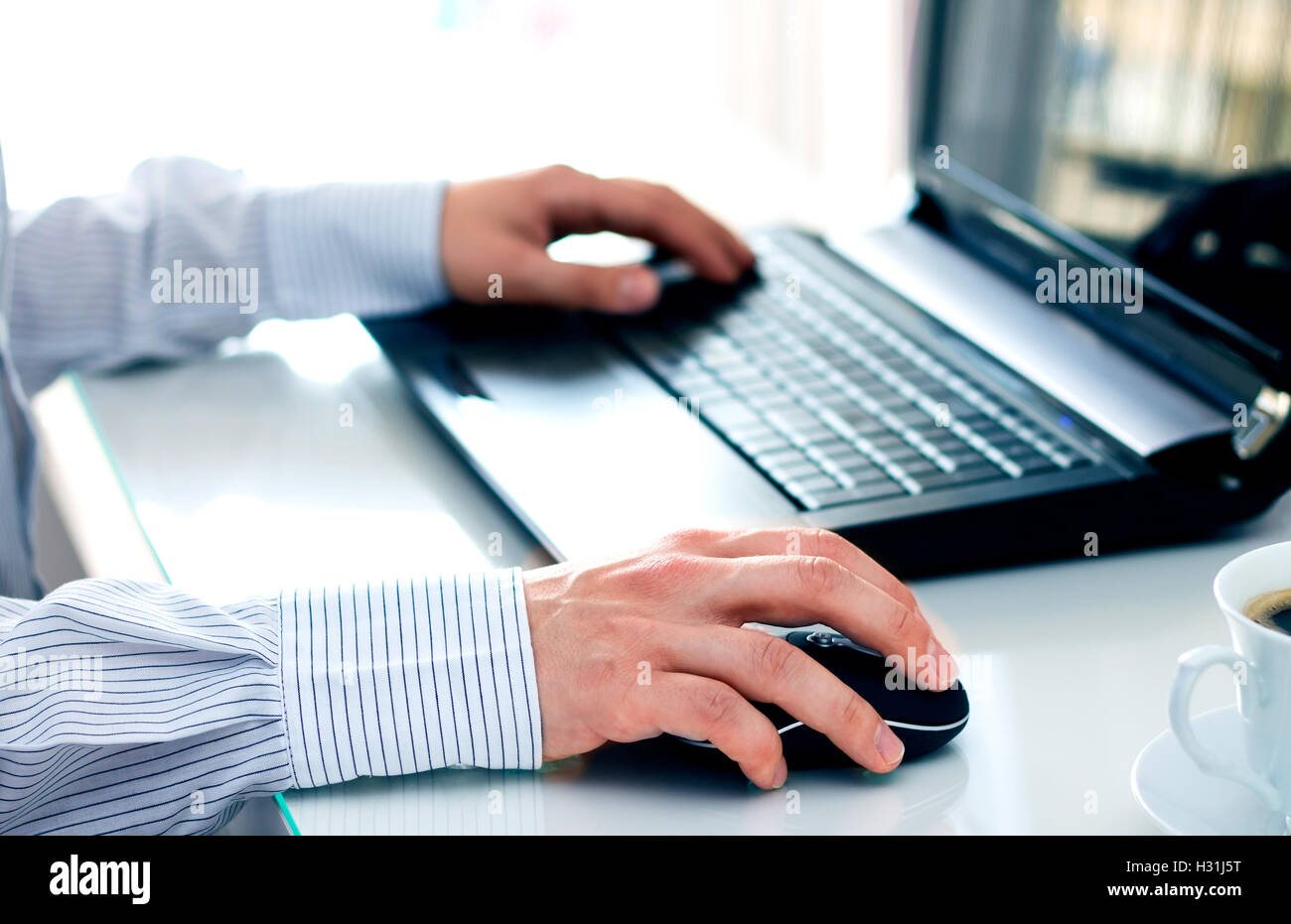 Businessman with computer in the office Stock Photo - Alamy
