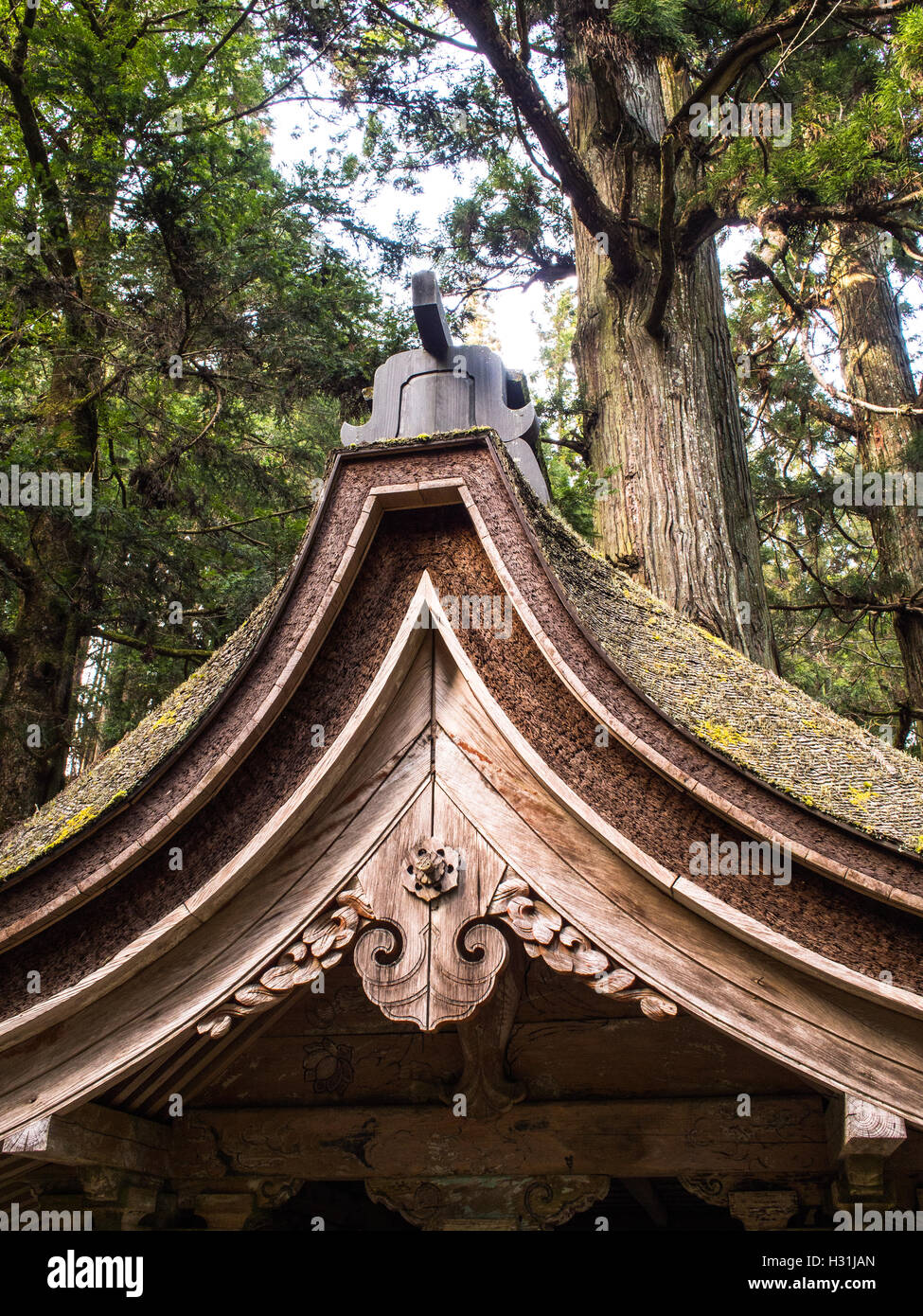 thatch roof gable with unpainted natural wood carving, small shrine ...