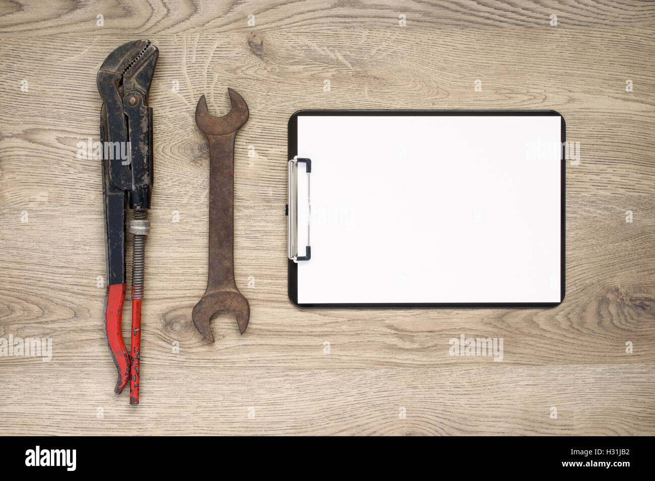 Rusty old hand tools with clipboard and empty white paper Stock Photo ...