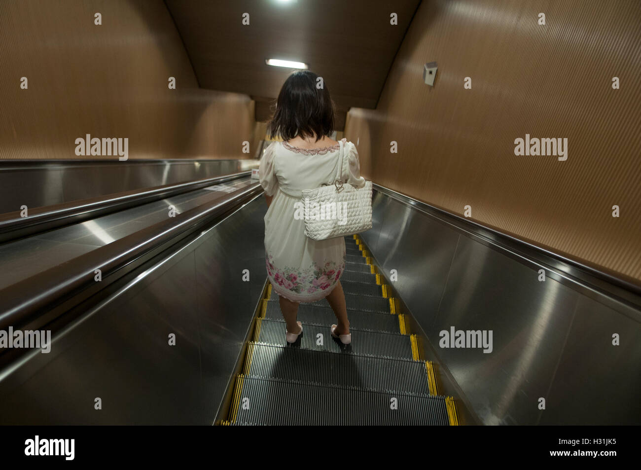 A commuter on her way to a subway metro station in Ginza district Tokyo ...