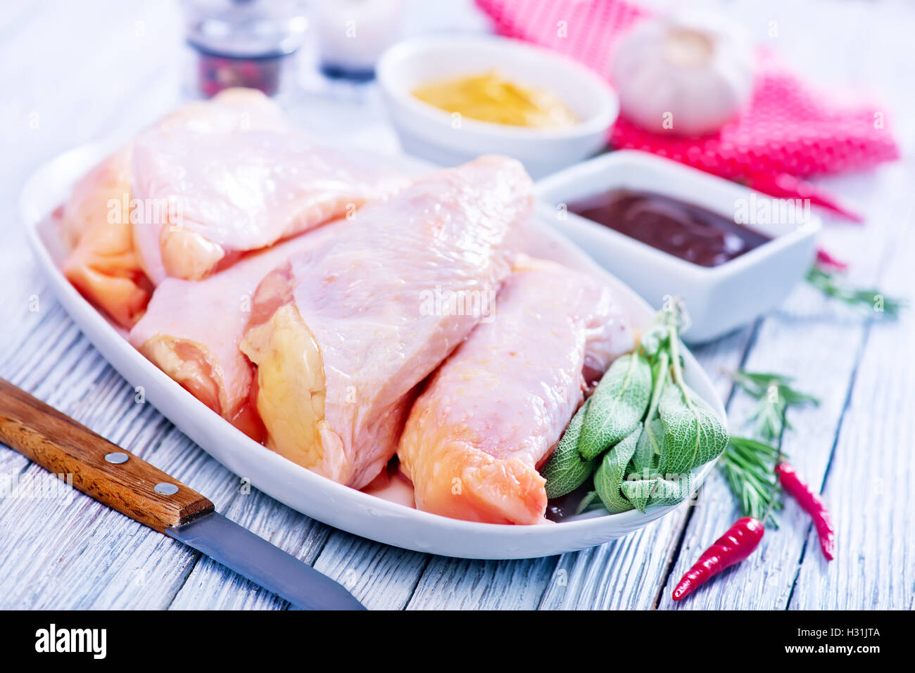 raw chicken legs on plate and on a table Stock Photo - Alamy