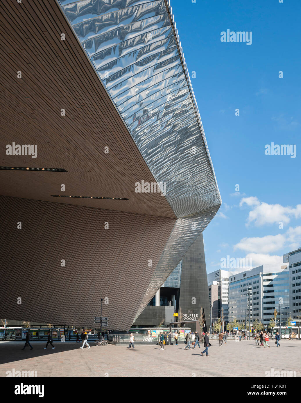 Main entrance angular view of metal clad canopy, high rise buildings on ...