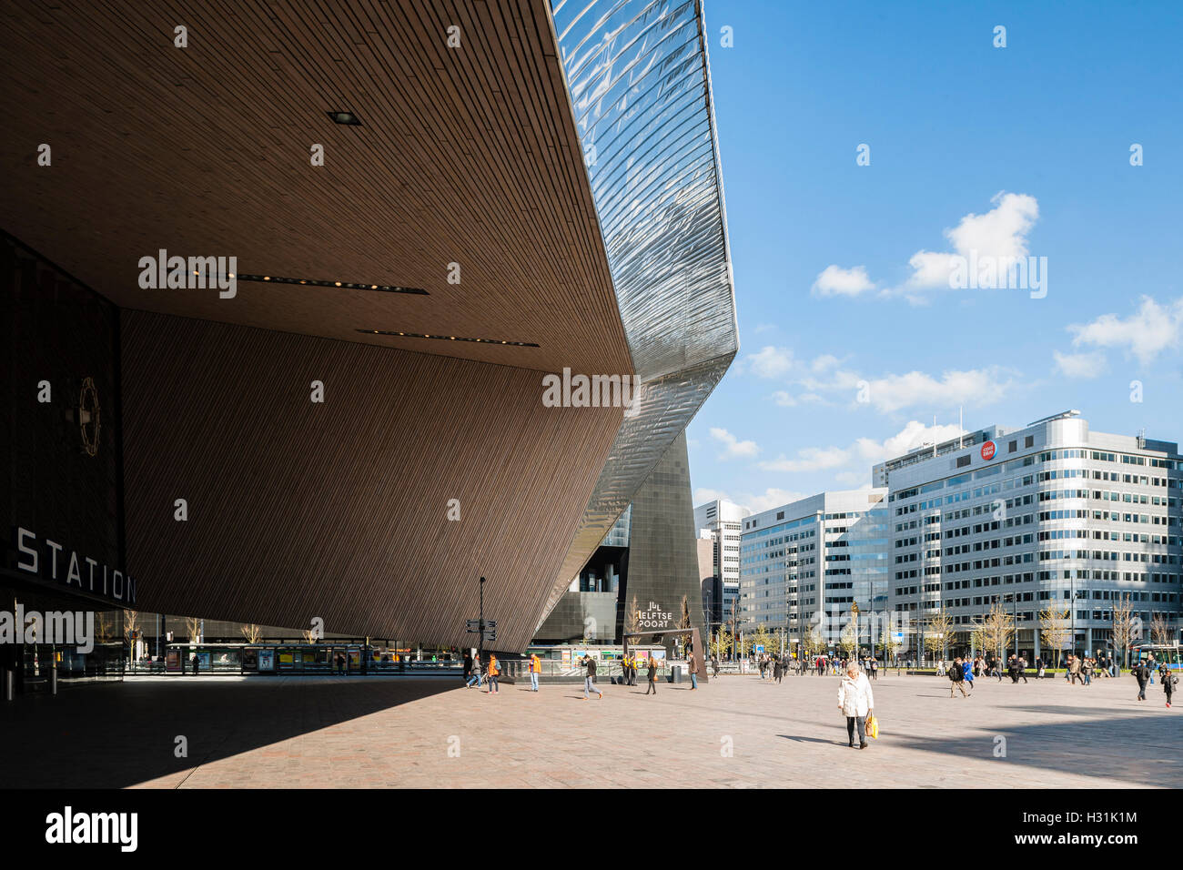 Main entrance angular view od metal clad canopy, high rise buildings ...