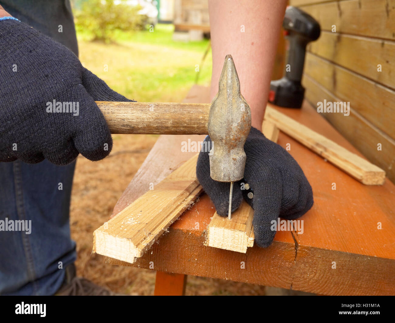 Man with rusty hammer and nails Stock Photo - Alamy