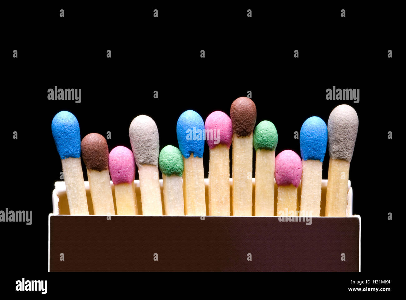 Multi-coloured matches in a box (a black background). Background layout ...