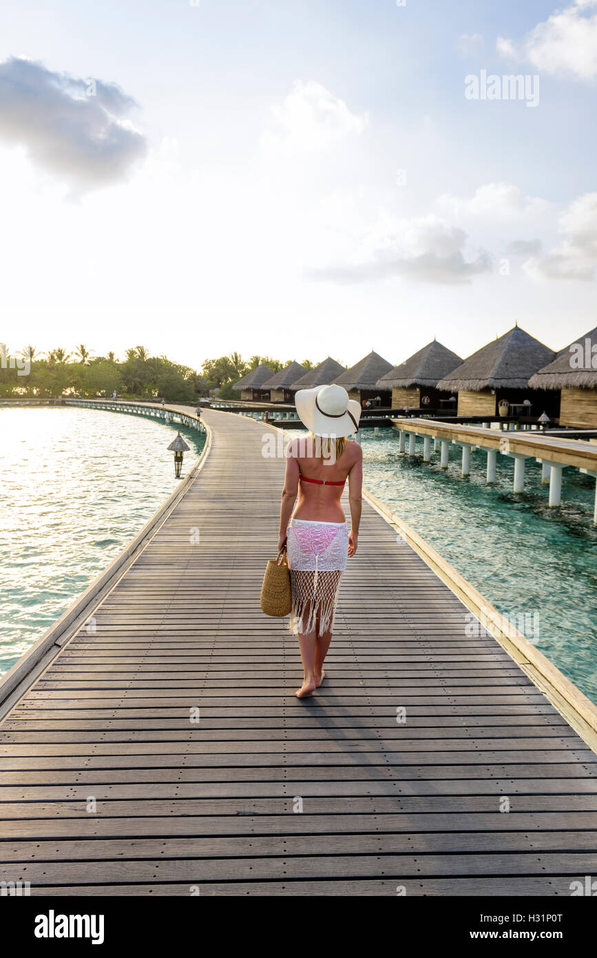 Rear View Of Woman Running Along Wooden Jetty Stock Photo - Alamy