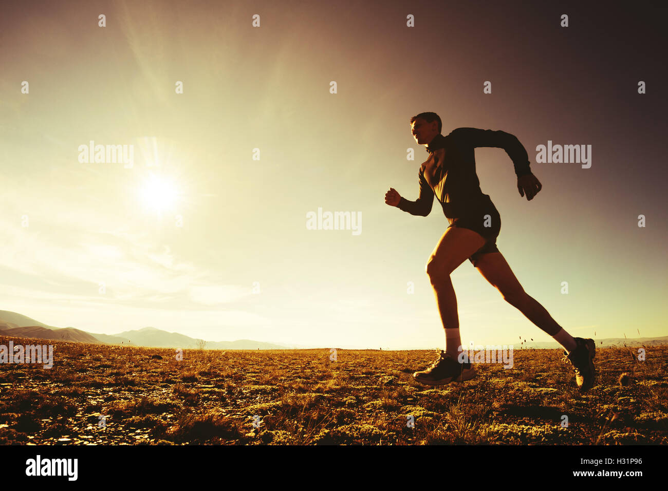 Sportsman running on the sky nature concept Stock Photo - Alamy