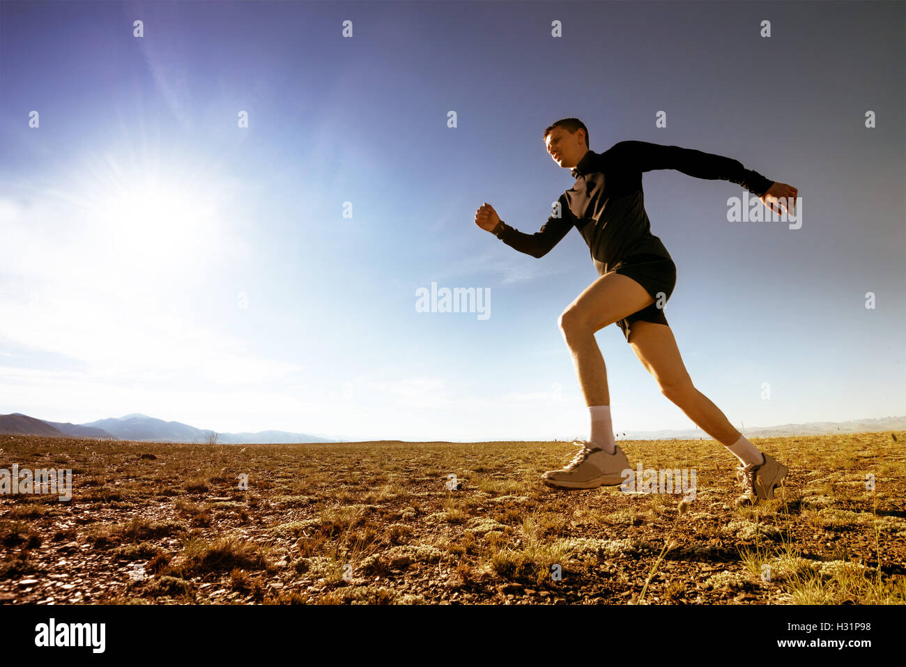 Sportsman running on the sky nature concept Stock Photo - Alamy