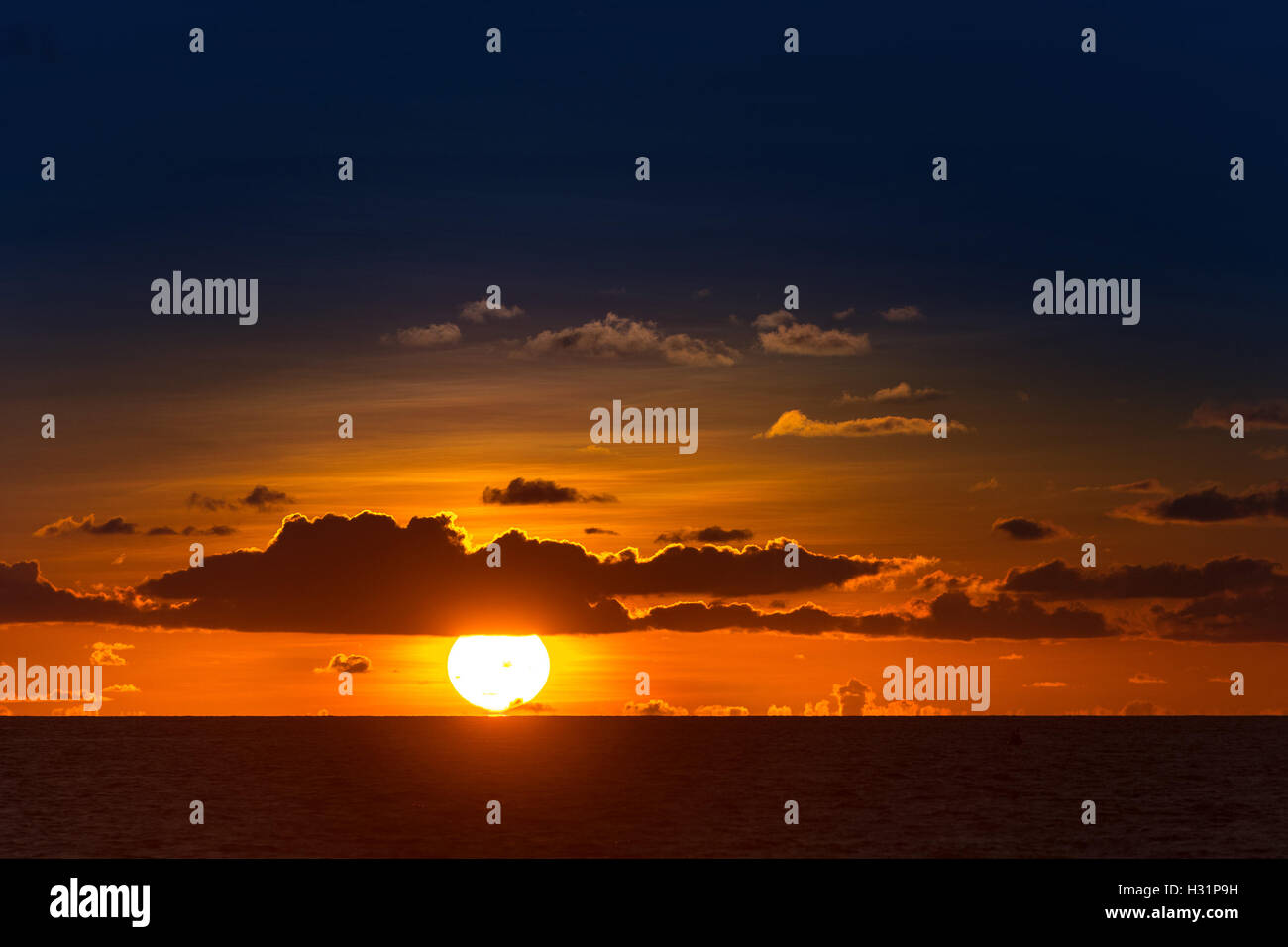 Red sunset over the sea, rich in dark clouds Stock Photo - Alamy