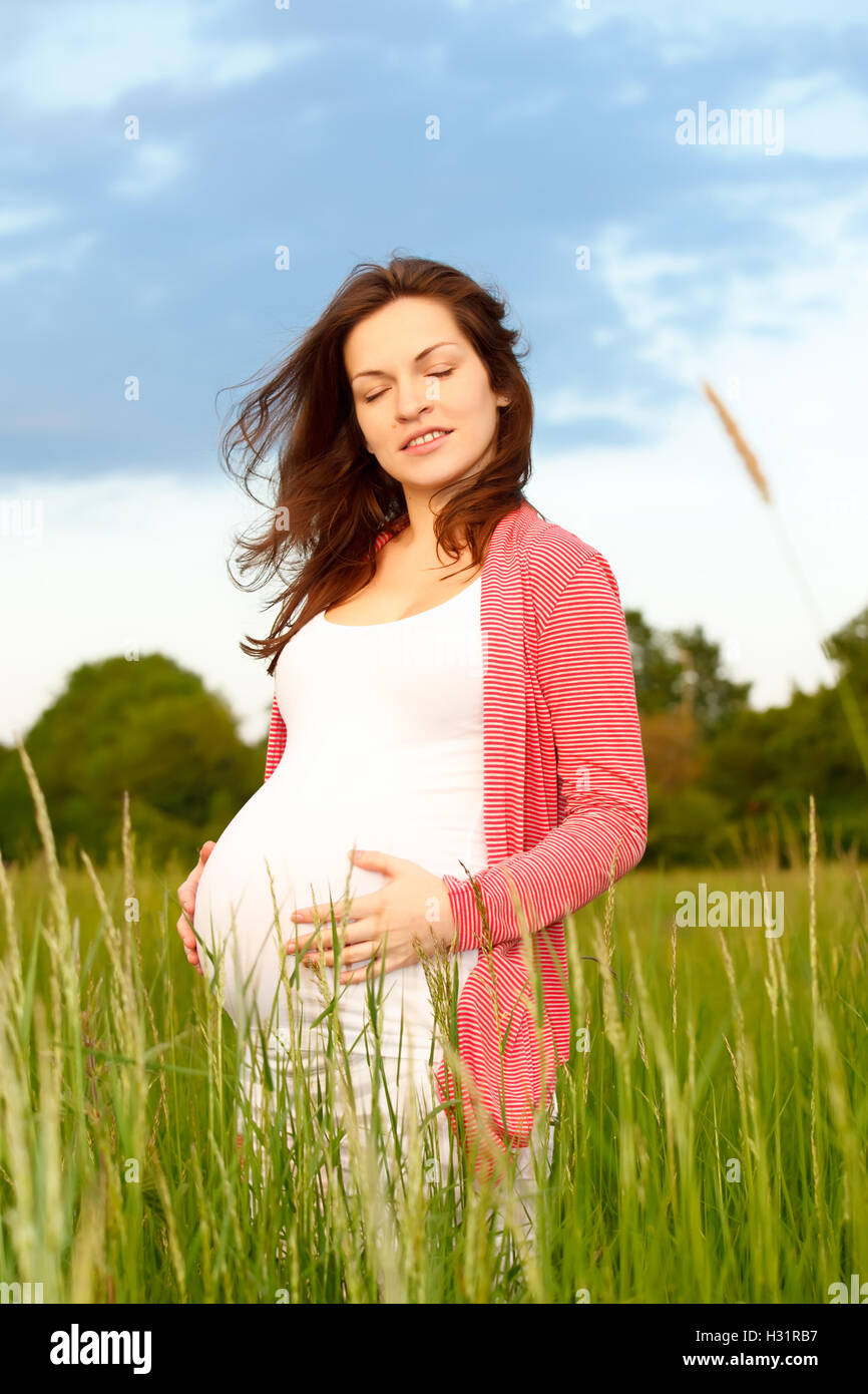 Beautiful pregnant woman in the park Stock Photo - Alamy