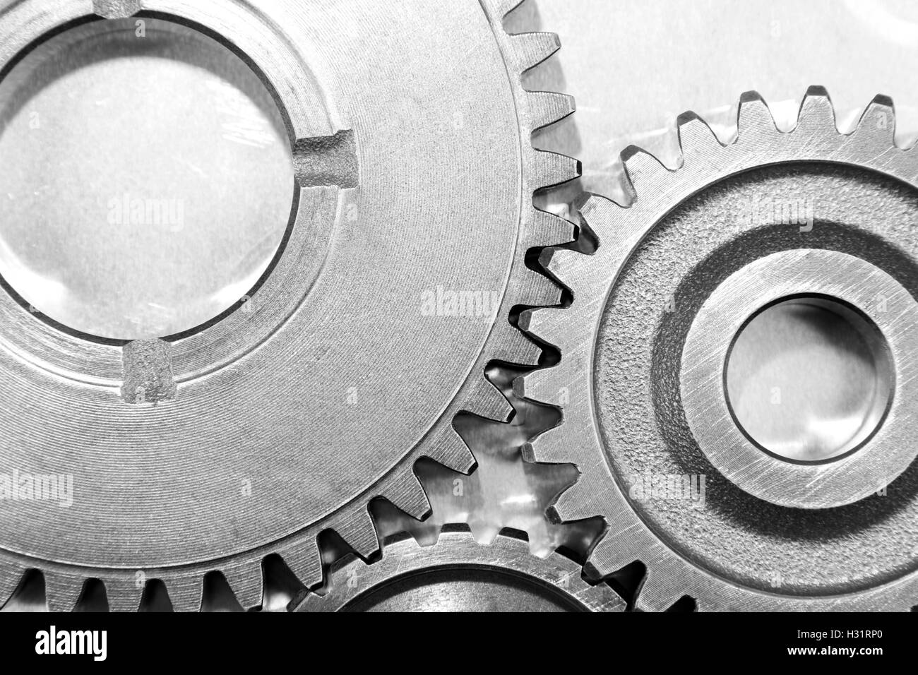 Metal cog gears joining together Stock Photo - Alamy