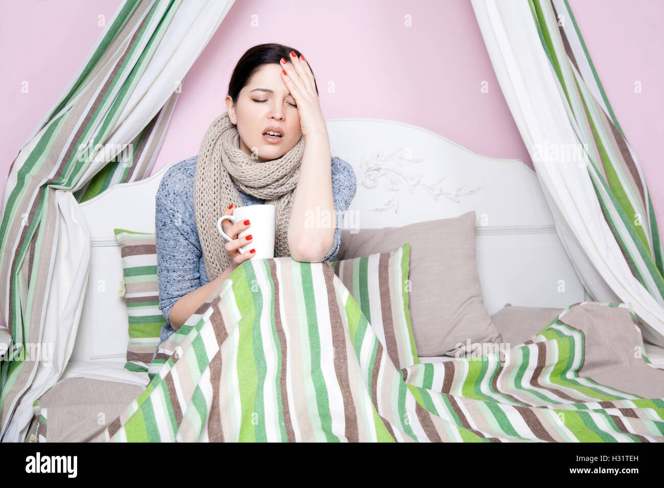 Young beautiful sick woman feeling ill and bad lying on bed suffering ...