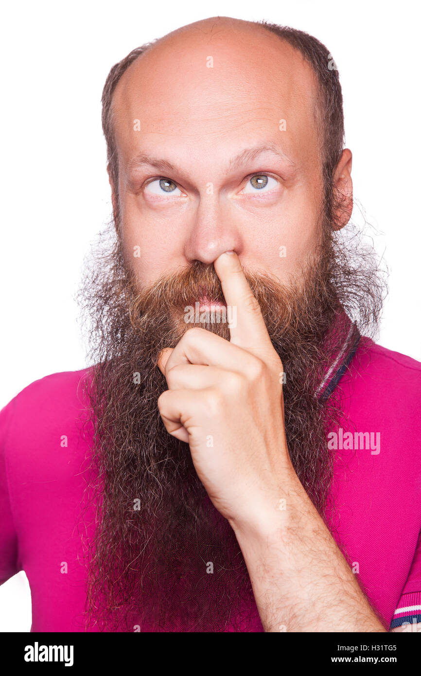 Portrait of a young blad bearded man with his finger in his nose ...