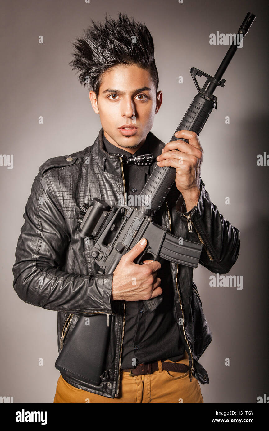 Young middle eastern man with black leather jacket in black suit ...