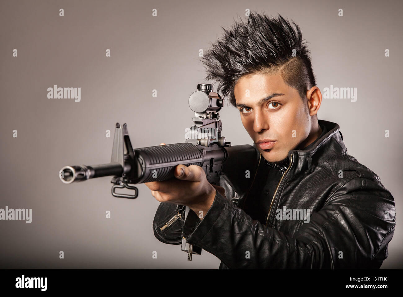 Young middle eastern man with black leather jacket in black suit ...