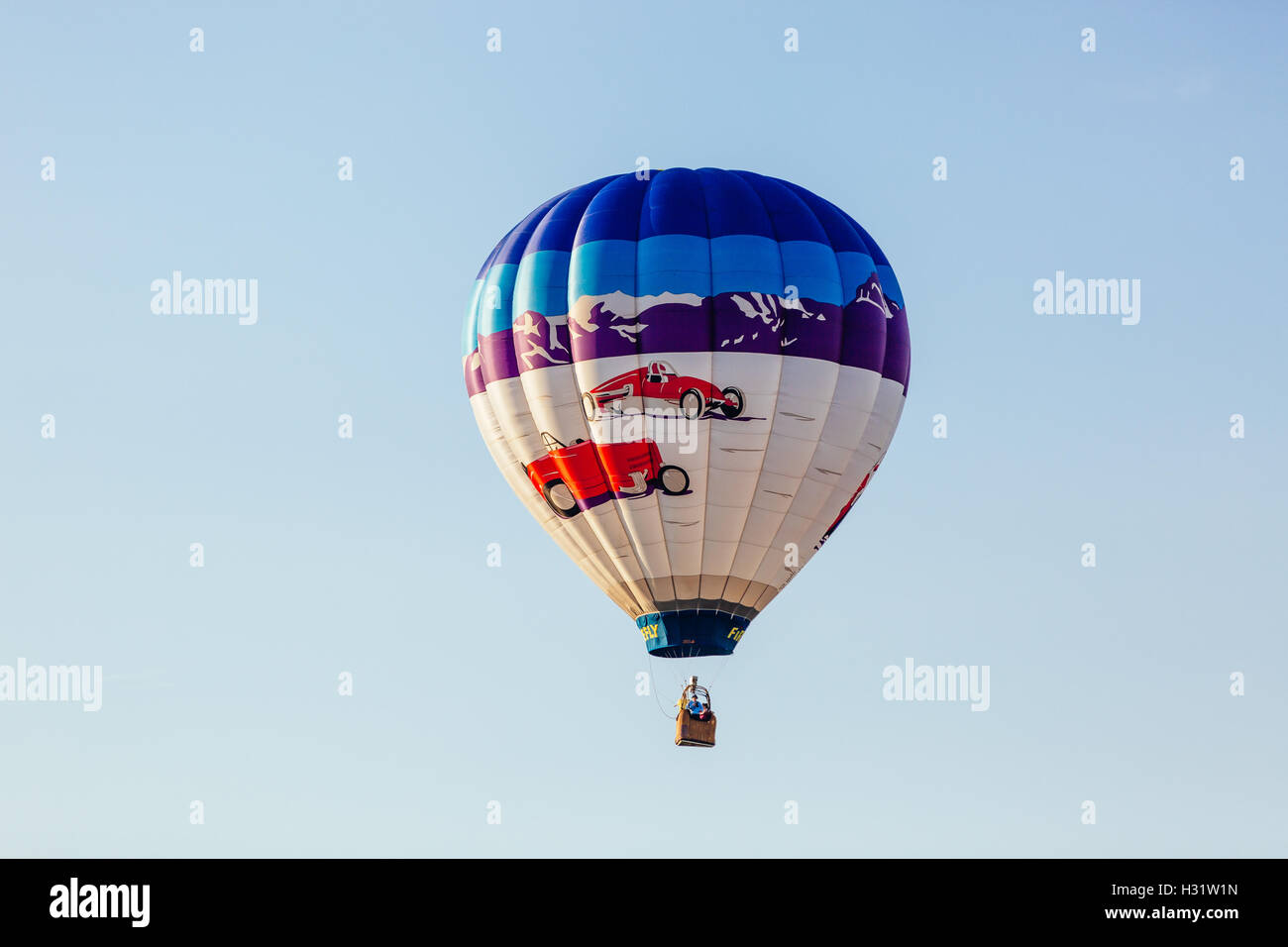 A single colorful hot air balloon isolated against a clear sky Stock ...