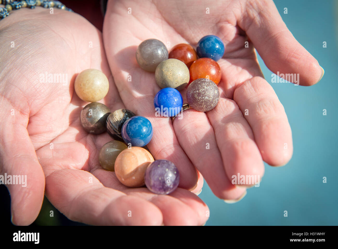 Traditional marbles in a person's hands in Cumberland, Maryland Stock ...