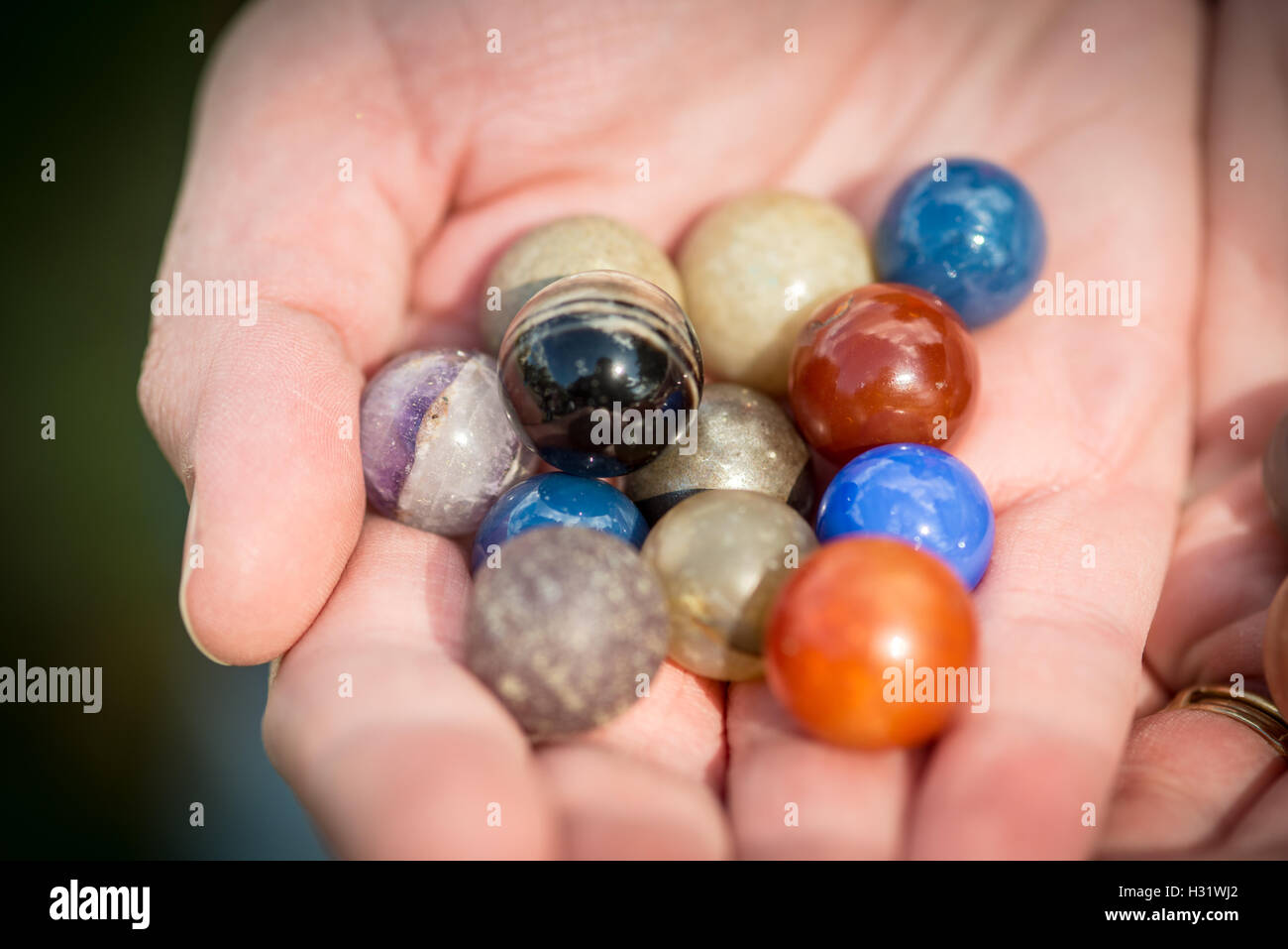 Traditional marbles in a person's hands in Cumberland, Maryland Stock ...