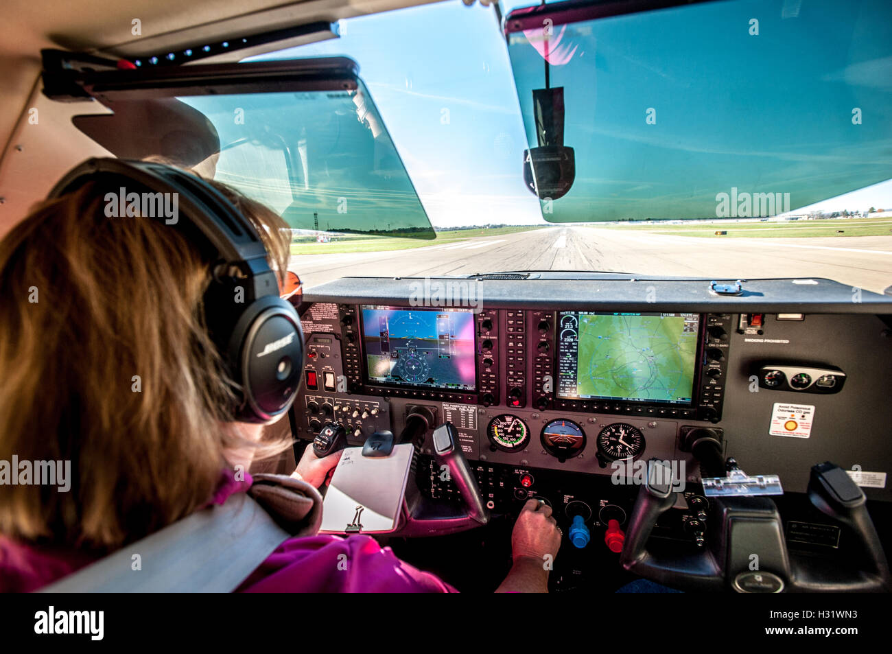 Woman in the cockpit of an airplane on a runway about to take off Stock ...