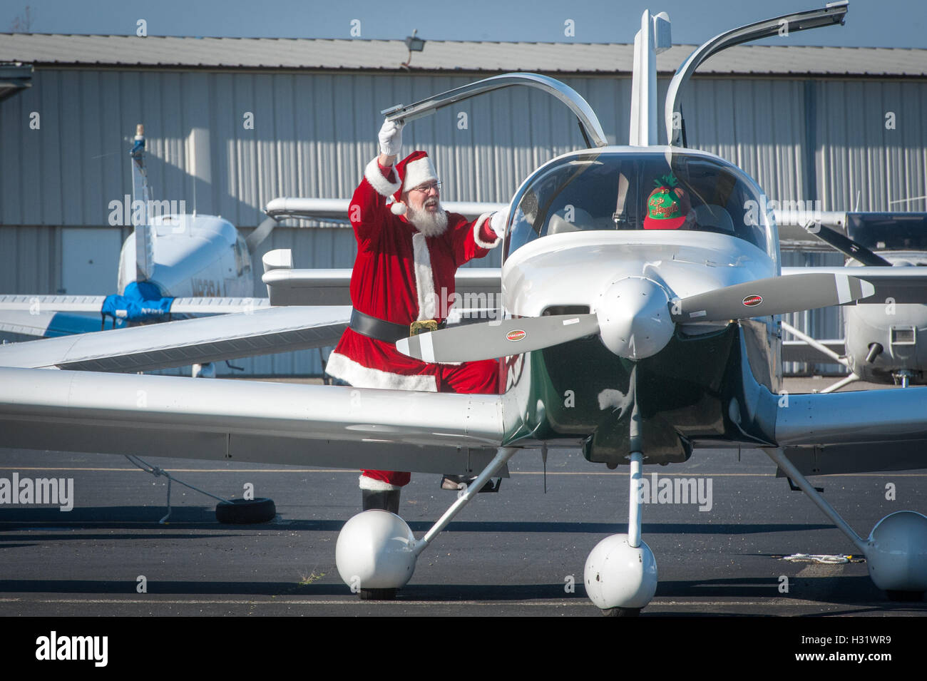 Santa Clause climbing into an airplane on Tangier Island in Virginia ...