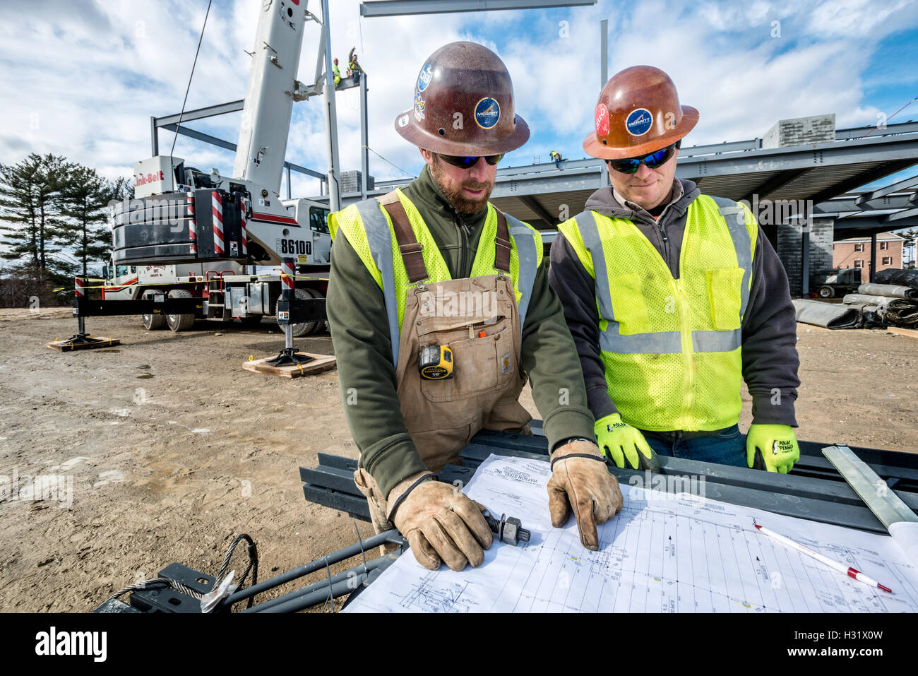 Construction site workers and plans hi-res stock photography and images ...