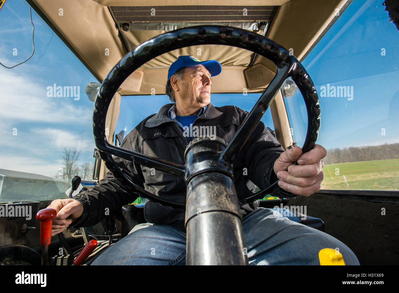 Farmer driving a John Deere Tractor on his Farm in Maryland Stock Photo ...