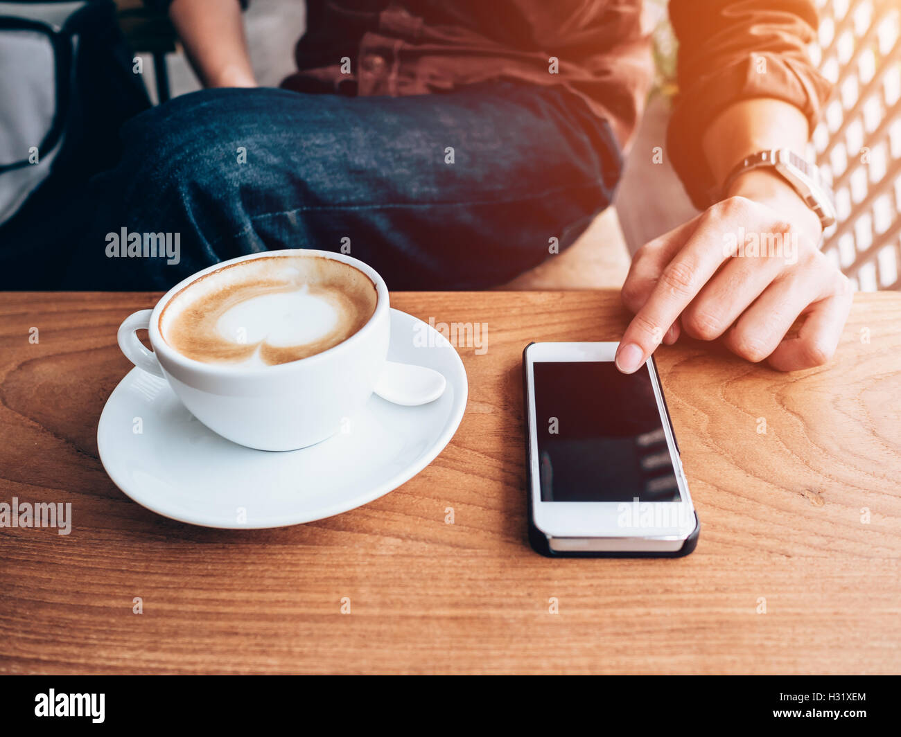 Close up hand man using phone in coffee shop with vintage filter Stock ...