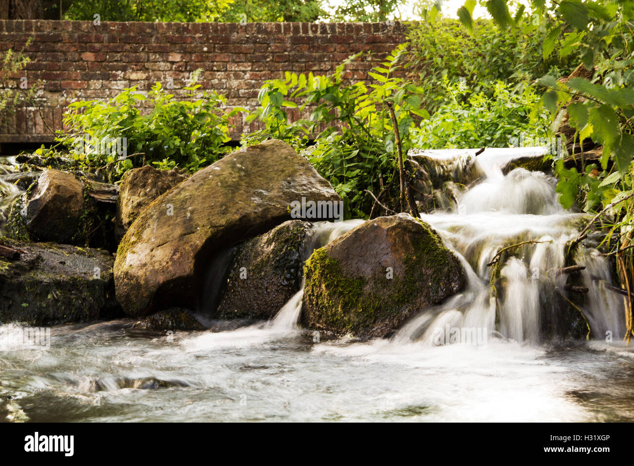 Long exposure shot of a waterfall in a small country stream Stock Photo ...